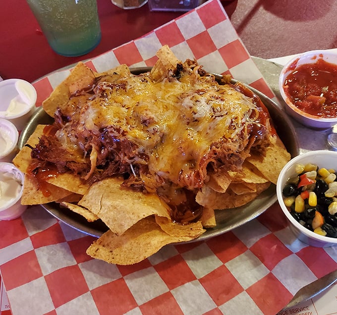 Nachos that don't skimp on the good stuff—a mountain of chips buried under an avalanche of pulled pork, cheese, and all the fixings. Sharing optional but not recommended.