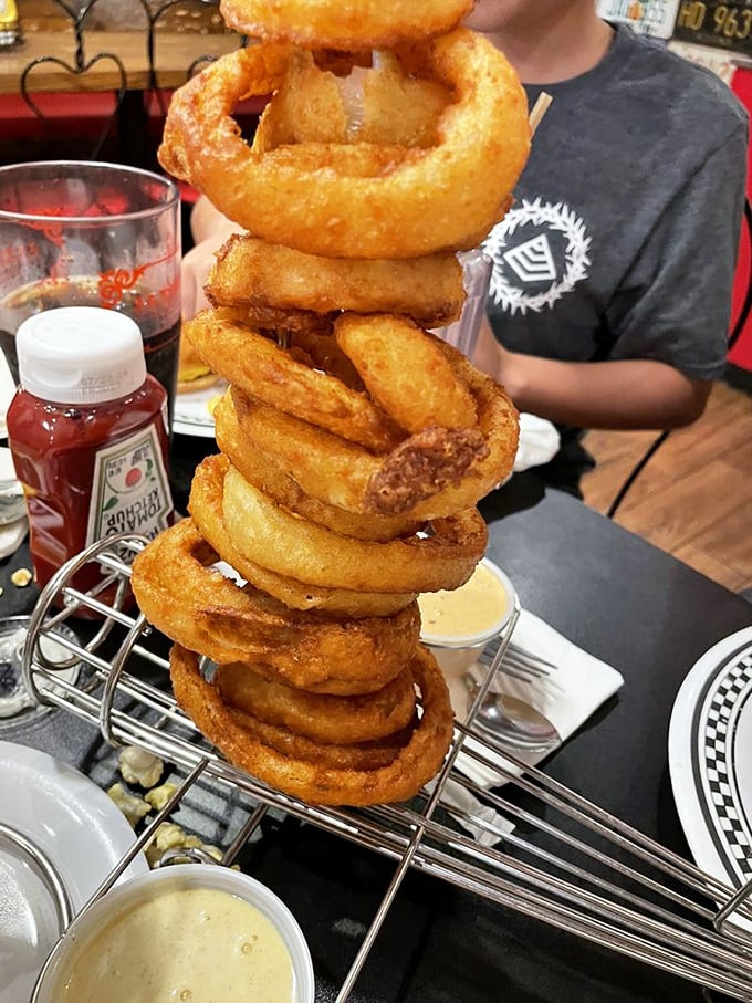 These onion rings aren't stacked—they're towering with the confidence of a Vegas poker player holding four aces. Crispy, golden, and unapologetically enormous.