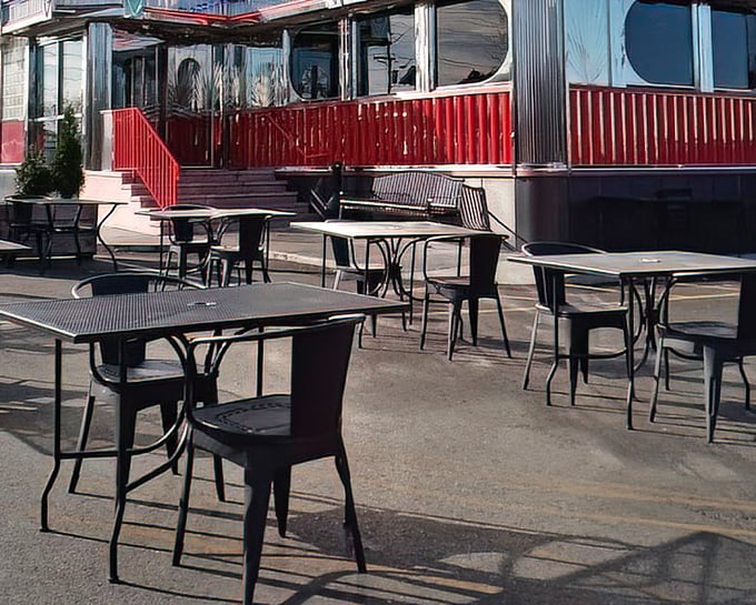 The outdoor seating area offers a breath of fresh air with your meal, where the chrome and neon aesthetic extends beyond the diner's walls.