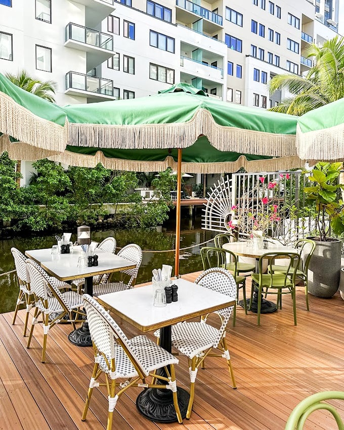 The outdoor seating area feels like you've stumbled upon a secret Parisian café that somehow floated across the Atlantic and landed in Florida.