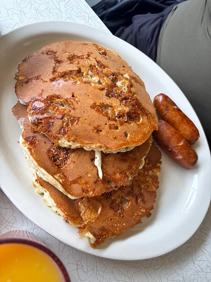 Pancakes stacked higher than your weekend expectations. Golden-brown with crispy edges, they're the breakfast equivalent of winning the lottery.