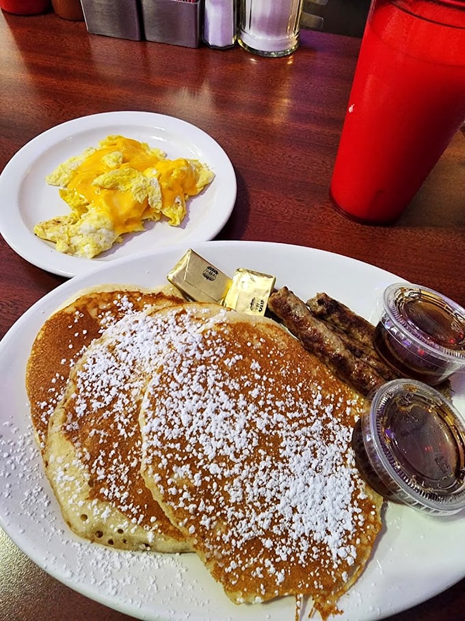 Golden pancakes dusted with powdered sugar arrive like edible sunshine, complete with butter pats and syrup for days.