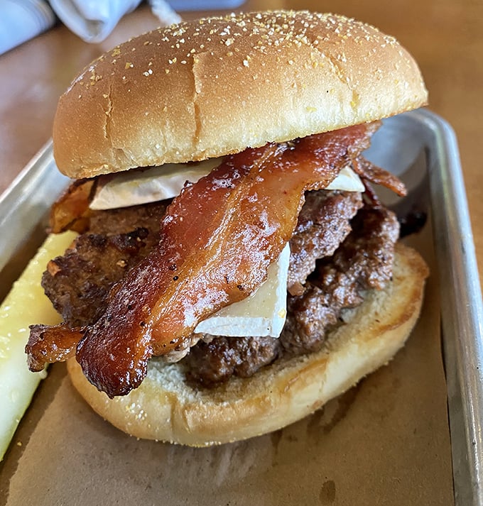 A bacon cheeseburger that means business, with strips of bacon thick enough to use as bookmarks.