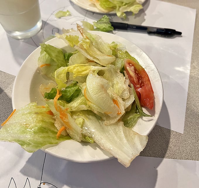 A salad that knows its role—the opening act that sets the stage without stealing the show. That tomato slice is the ruby in the crown.