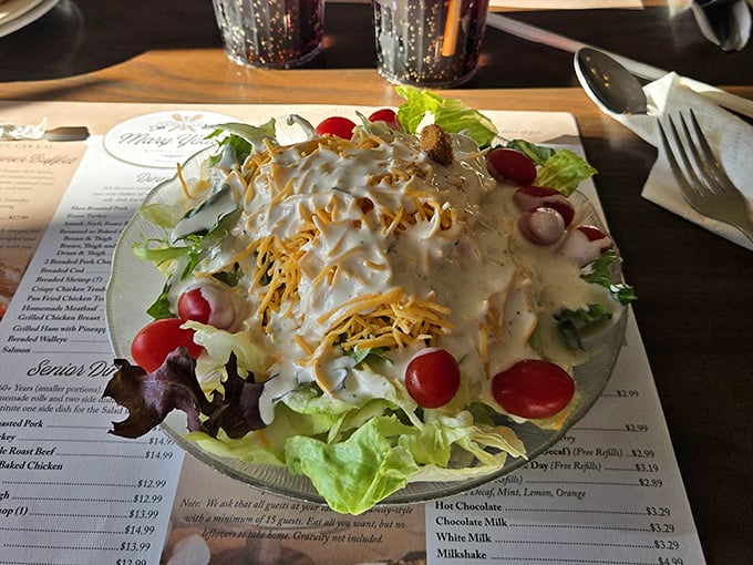 Garden-fresh salad topped with shredded cheese and house dressing—proof that Amish country knows vegetables aren't just what food eats before becoming dinner.