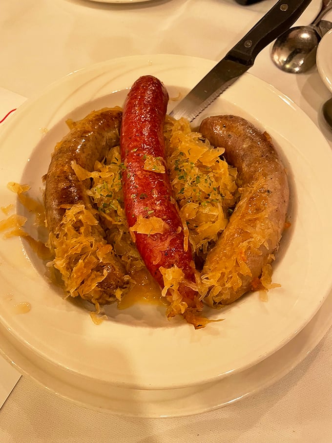 A plate of traditional German sausages nestled on sauerkraut—proof that Frankenmuth takes its Bavarian heritage seriously and deliciously.