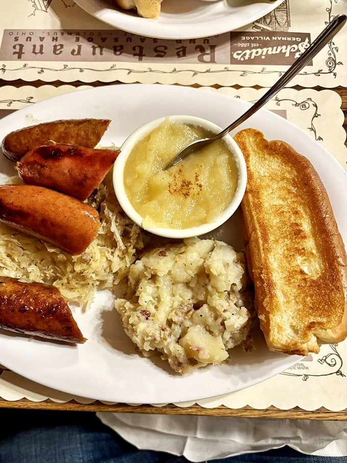 The sausage sampler with sauerkraut, potato salad, and applesauce—a trilogy more satisfying than any Hollywood blockbuster you'll see this year.