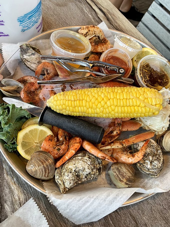 A seafood feast fit for Neptune himself – shrimp, clams, and corn on the cob, all arranged with the casual elegance of a coastal picnic.
