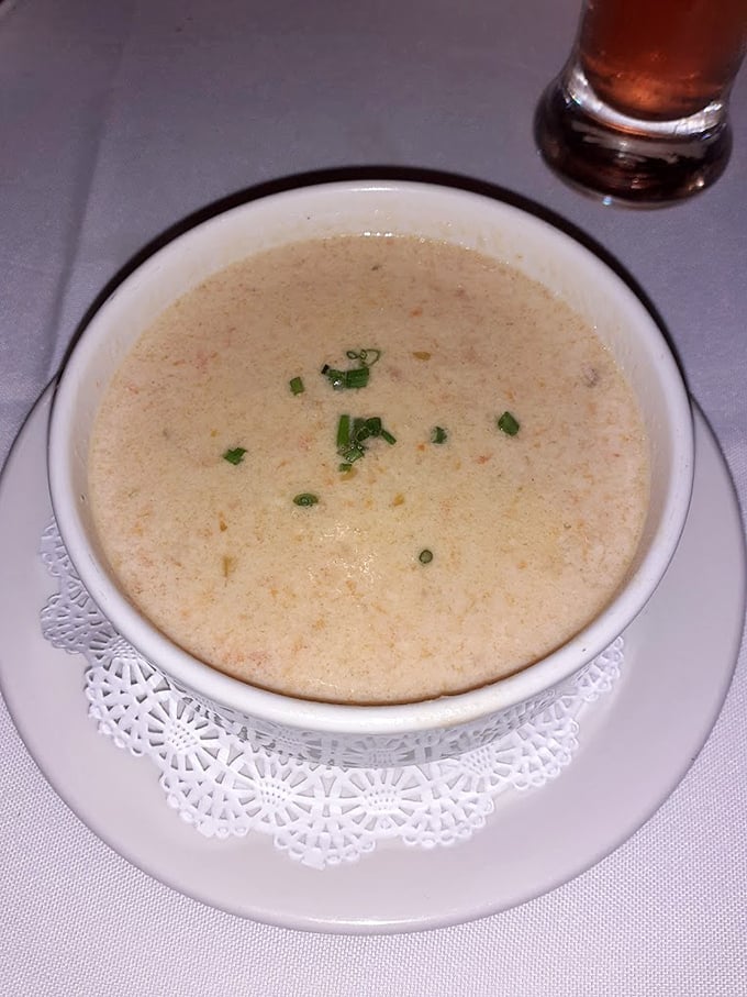 She-crab soup that's richer than most retirement portfolios—creamy, delicate, and garnished with just enough green to pretend it's not pure indulgence.