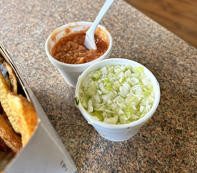 The supporting actors deserve their own spotlight: tangy tomato rice "hot sauce" and freshly chopped coleslaw. These sides aren't afterthoughts—they're essential characters.