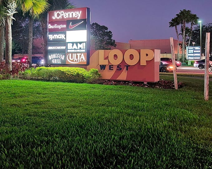The Loop West sign glows like a retail lighthouse, guiding bargain hunters safely to shore after dark.