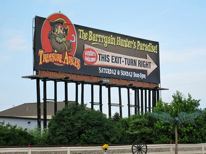 The siren call of bargain hunting. This roadside billboard serves as a beacon to the deal-obsessed, promising weekend adventures for the fiscally savvy.