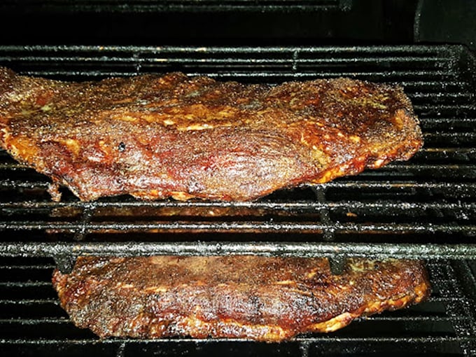 Meat on the smoker—the barbecue equivalent of watching paint dry, except the end result makes you weep with joy instead of boredom.
