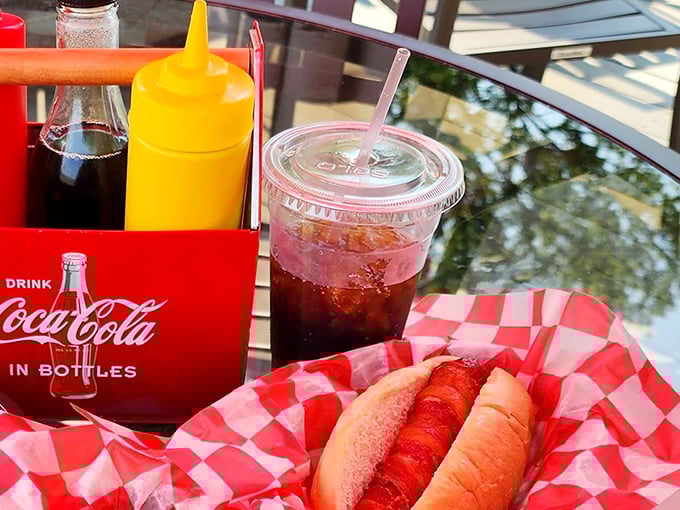 The classic American trinity: Coca-Cola, mustard, and a perfectly dressed dog. Some traditions don't need improving, just celebrating.