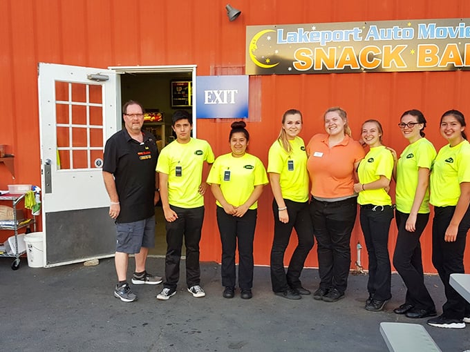 The cheerful crew that keeps the movie magic flowing, wearing bright yellow shirts that somehow match their enthusiasm for preserving this slice of Americana.