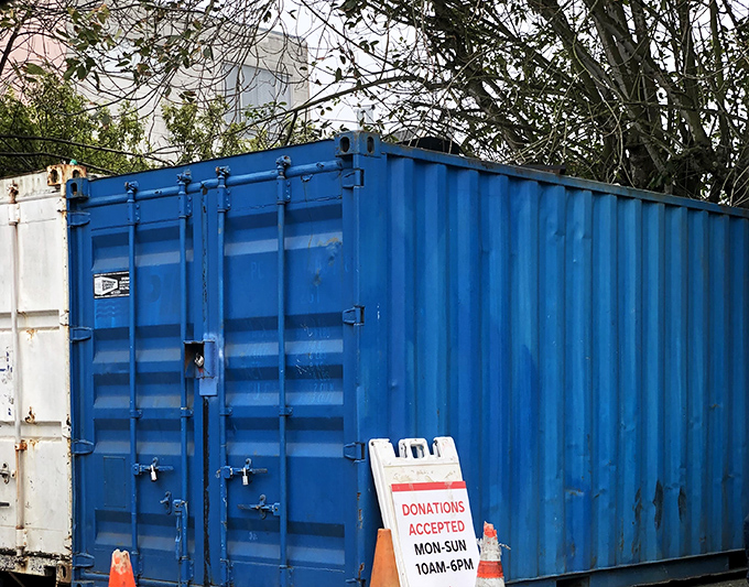 The blue donation container – where yesterday's impulse purchases become tomorrow's treasures in the great circle of retail life.