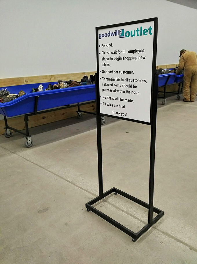 The rules of engagement for Goodwill's outlet section – a gentle reminder that thrifting is both sport and art form.