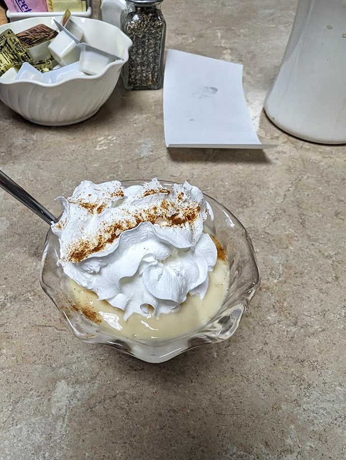 This homemade pudding topped with whipped cream isn't just dessert—it's a time machine back to your grandmother's kitchen on Sunday afternoons.