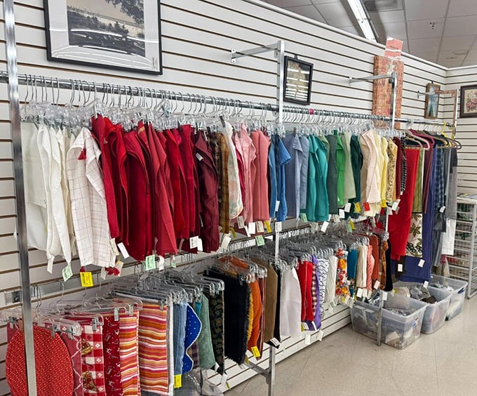 Color-coded clothing racks organized with military precision make finding that perfect vintage button-down easier than locating matching socks at home.