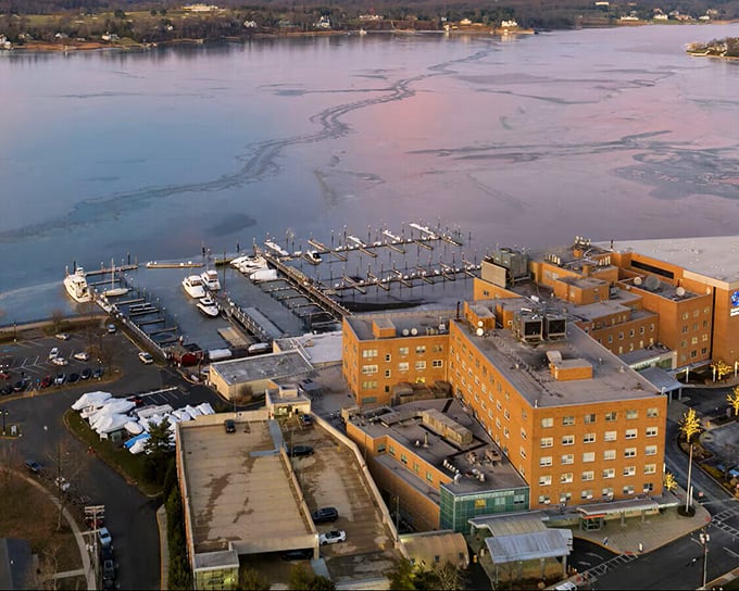 Winter transforms the Navesink into a serene, ice-flecked landscape, where marina docks stand ready for the spring thaw and boating season ahead.