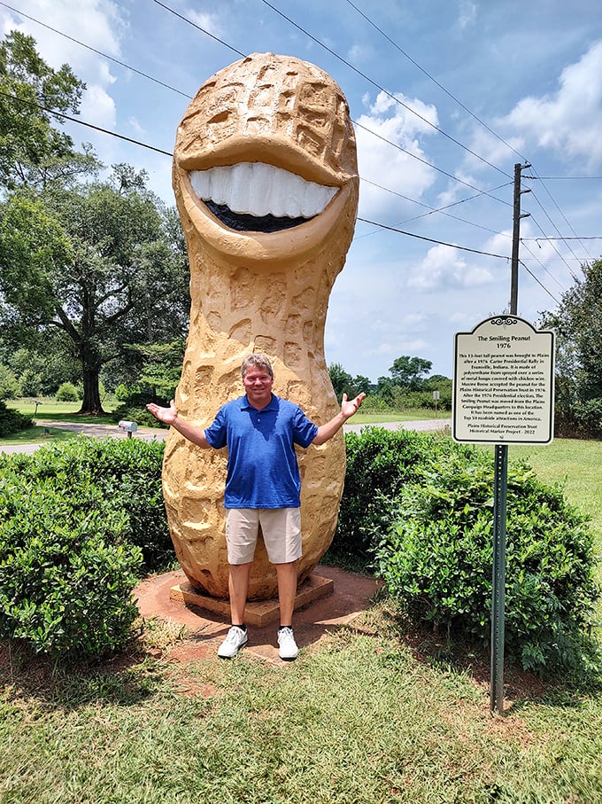 Size matters when it comes to roadside attractions. This visitor seems equally delighted and bewildered by the towering nutty grin.