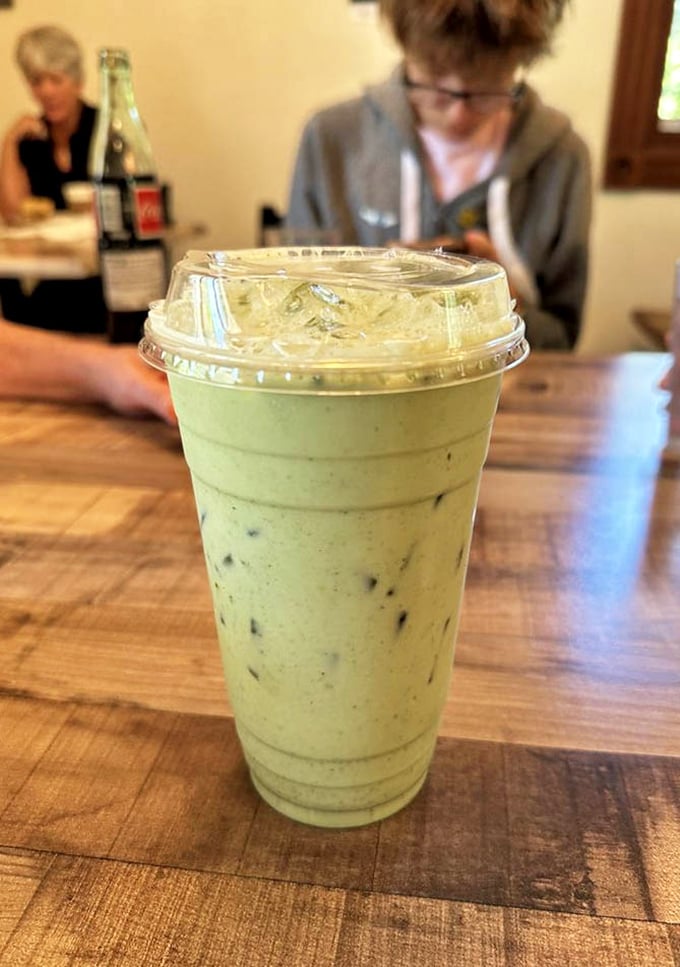 That vibrant matcha latte isn't just a drink—it's a moment of zen in a cup, the perfect companion to whatever treat you've selected.