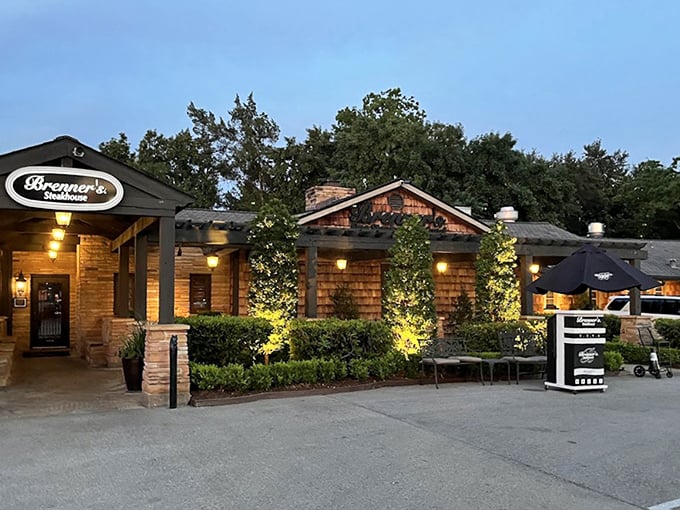 Brenner's wooden exterior glows with warm invitation. The landscaped entrance feels like arriving at a friend's luxury cabin.