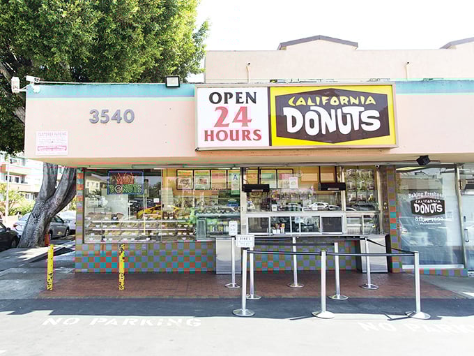 California Donuts' bright facade shines like a 24-hour lighthouse for late-night sugar seekers citywide.