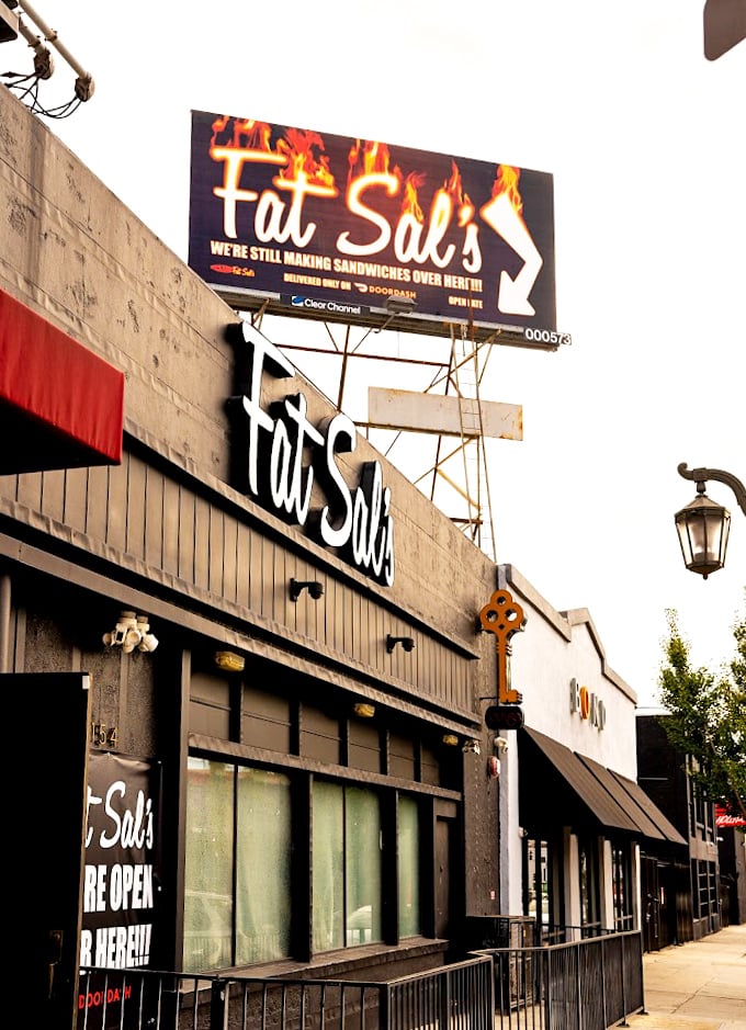 That flaming billboard doesn't whisper subtlety, but sometimes the best food comes with bold promises.