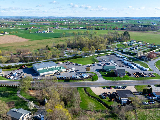 Gordonville's bird's-eye view reveals the delicate dance between commerce and countryside—where parking lots politely bow to rolling farmland.