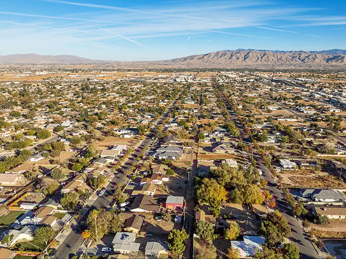 Hesperia's grid of desert dreams unfolds beneath mountains that stand guard like ancient sentinels—retirement with a view!
