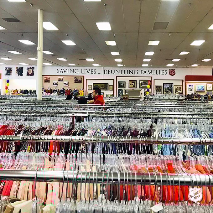"Saving Lives... Reuniting Families" – The Salvation Army's mission statement hangs above a rainbow of organized clothing.