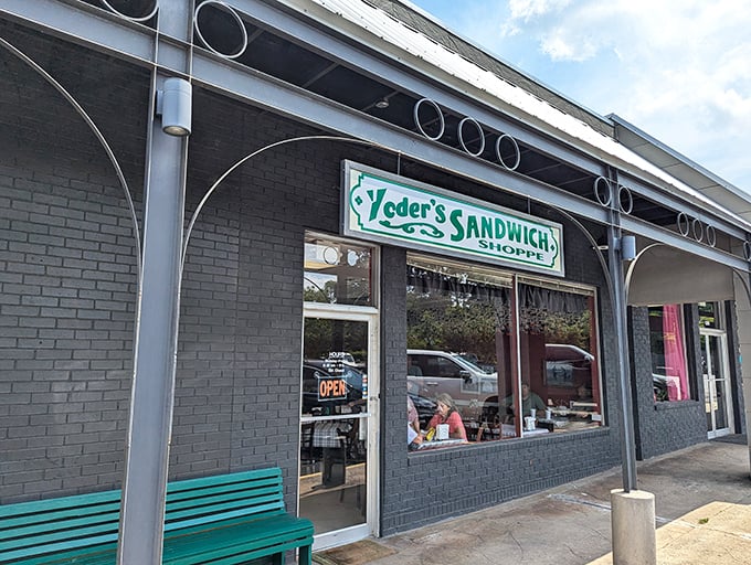 That teal bench outside is like a front porch swing for sandwich enthusiasts. Yoder's charming storefront brings small-town warmth to every bite – no hurry, just flavor.