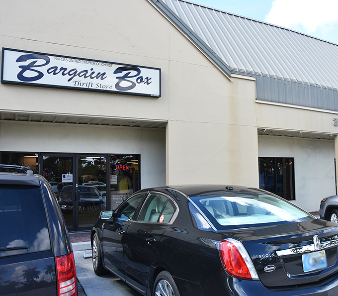 A closer look at Bargain Box shows luxury cars parked outside—a hint that donations here might include some high-end finds!