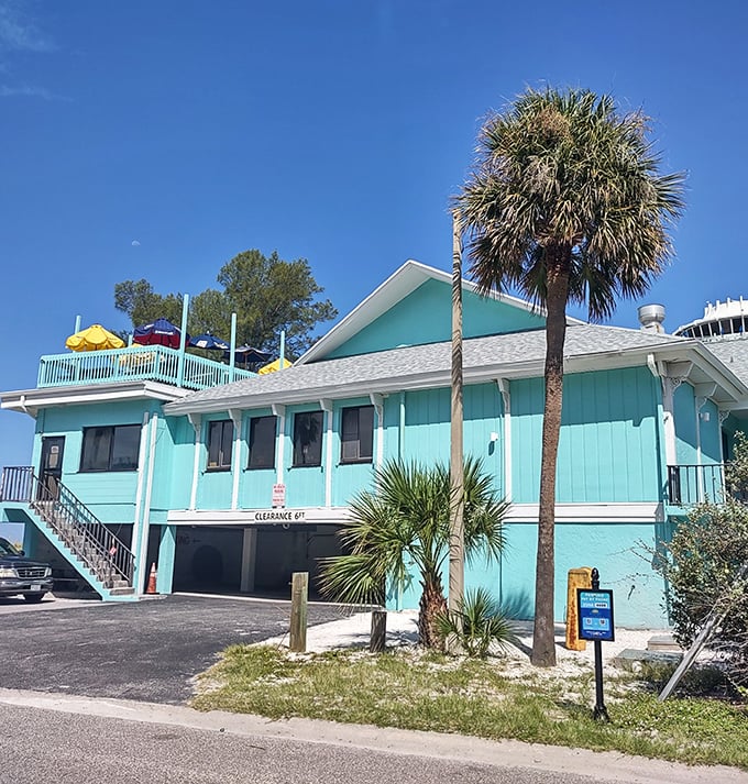 The perfect Florida color palette—turquoise building, blue sky, and green palm trees. Crabby Bill's looks like a postcard you can eat at!