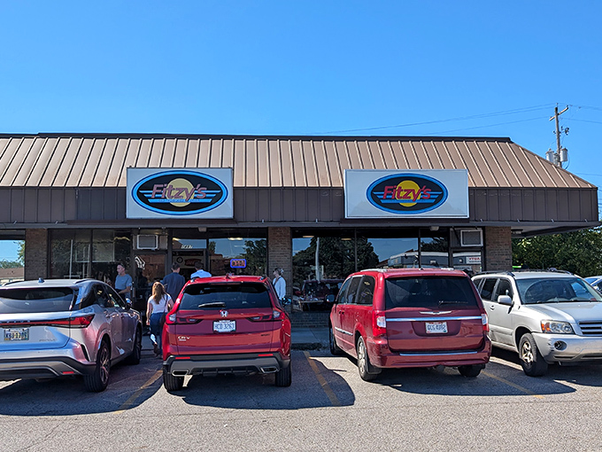 The pilgrimage to Fitzy's Old Fashioned Diner has begun! Those red minivans aren't just parked—they're making a pit stop on the highway to flavor town.