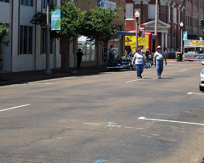 Street festival vibes in Greenwood where bounce houses and oyster signs promise entertainment without breaking budgets.