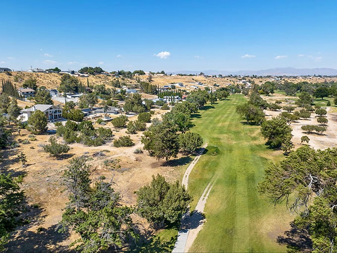 That emerald fairway cuts through Hesperia's desert palette like a cool oasis—where retirement means choosing between golf clubs and hiking boots daily.