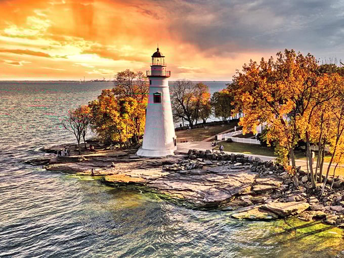 Sunset transforms Marblehead Lighthouse into a painting come to life, with autumn trees framing this iconic Lake Erie landmark.