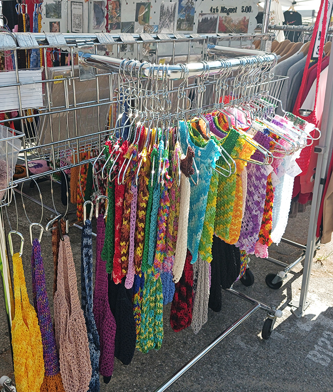 Handmade scarves dance in the gentle breeze, each one telling a different color story.