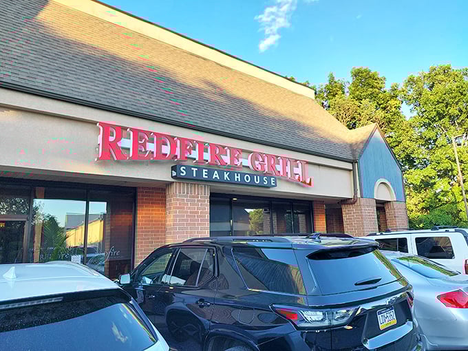 The evening light makes Redfire's sign pop against the twilight sky—a beacon for hungry Hockessin locals.