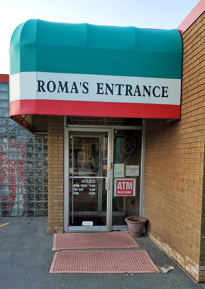 The distinctive curved awning creates an inviting portal to pizza perfection that honors old-world Italian traditions.