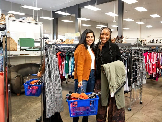 Happy hunters with full baskets—the universal sign of a successful expedition into the wilds of secondhand shopping. Their smiles say it all: mission accomplished.