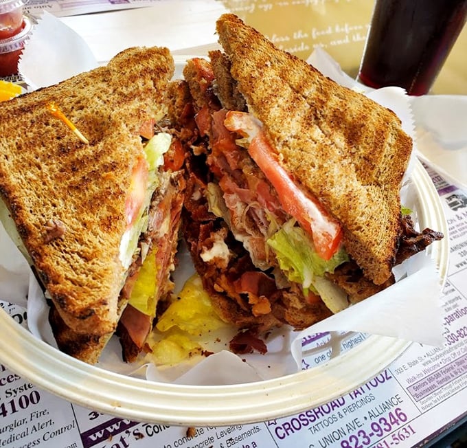 This isn't just a sandwich—it's a skyscraper of bacon, veggies, and toast that makes you wonder if your mouth is big enough.