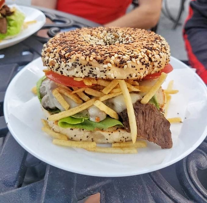 This isn't just a bagel sandwich—it's an architectural marvel of seeds, meat, and veggies that somehow defies gravity and good manners.