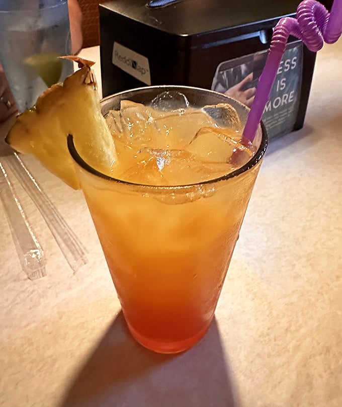This sunset-in-a-glass Bahama Mama makes you wonder if they've somehow bottled tropical vacation memories and added rum.
