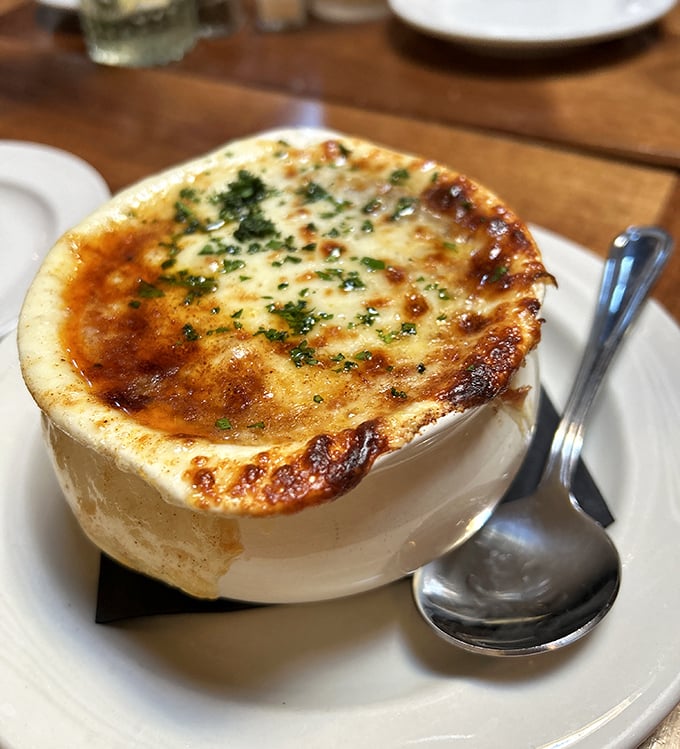 This isn't just onion soup – it's a comfort food masterpiece with a crown of melted cheese that stretches dramatically with each spoonful.