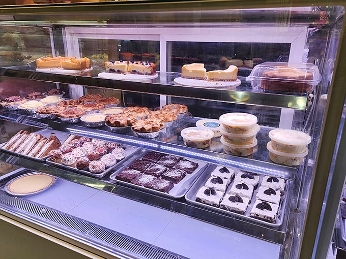 The display case—a glass-fronted gallery where dessert masterpieces await adoption by hungry market-goers.