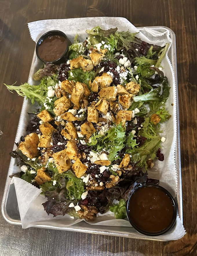 Even their salads mean business – grilled chicken, fresh greens, and a balsamic dressing that makes eating vegetables feel like cheating on your diet.