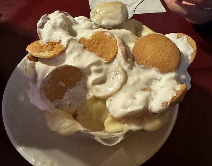 This isn't just banana pudding—it's Southern comfort in dessert form. Vanilla wafers standing proud in clouds of cream, waiting to dissolve into pure happiness.